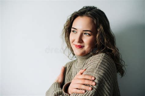 Romantic Wife Eagerly Anticipating Husbandand X27 S Return Standing By Window With Arms Wrapped