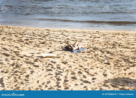 A Woman Lying On The Beach Sand Outdoors Sunbathing Editorial Stock