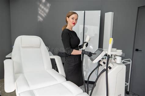 Doctor Cosmetologist Adjusts The Device For Photorejuvenation Using The