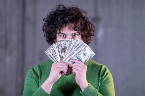 Business Man Displaying A Spread Of American Dollar Cash Money 12449652