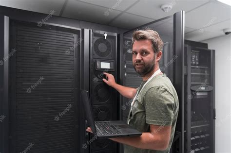 Premium Photo Data Center Engineer Using Laptop Computer Server Room Specialist Facility With