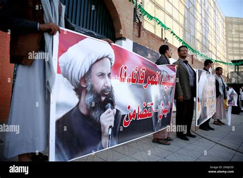 Shiite Rebels Known As Houthis Hold Posters Of Late Shiite Cleric Nimr Al Nimr Who Was