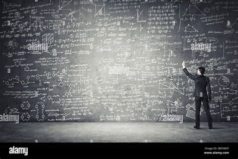 Businessman Or Teacher Drawing Science Sketches At Blackboard Stock