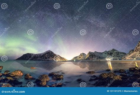 Panorama Of Aurora Borealis With Milky Way Galaxy Over Snow Mountain In