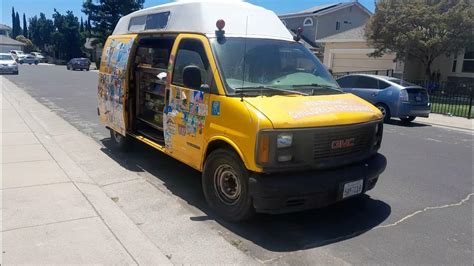 Getting Ice Cream From The Yellow Ice Cream Truck On A Very Sunny Day