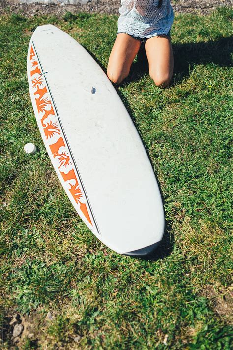 Woman Waxing Her Surfboard By Stocksy Contributor Michela Ravasio Stocksy