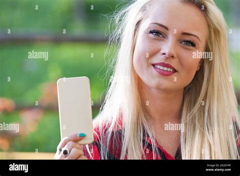 Blonde Girl Showing A Mobile Phone Stock Photo Alamy