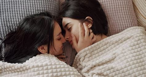 Couple Of Women Hug Each Other Warmly And Relax At Home In The Bedroom