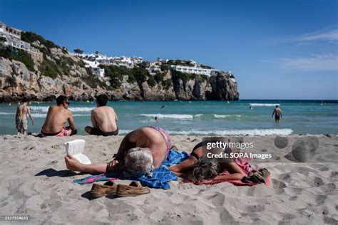 Beachgoers Are Seen At The En Porter Beach Sunbathing And Relaxing