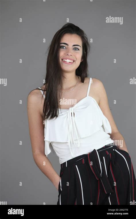 Cheerful Cute Latino Girl Posing On Grey Background Stock Photo Alamy