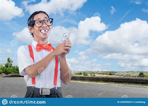 Asian Nerd With An Ugly Face Holding Money Stock Photo Image Of Geek Asian 242936254