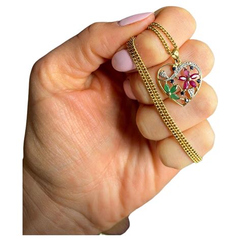18ct Gold Heart Floral Design Pendent Set With Rubys Emeralds And