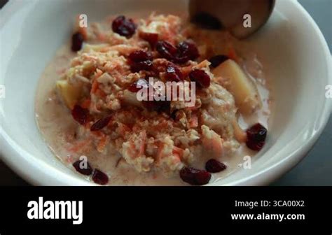Cozy Healthy Breakfast Bowl Filled With Oatmeal Apple Slices Grated Carrots And Dried