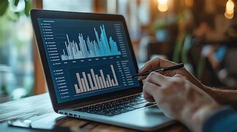 A Person Analyzing Data On A Laptop Showcasing Graphs And Charts In A Modern Workspace With A