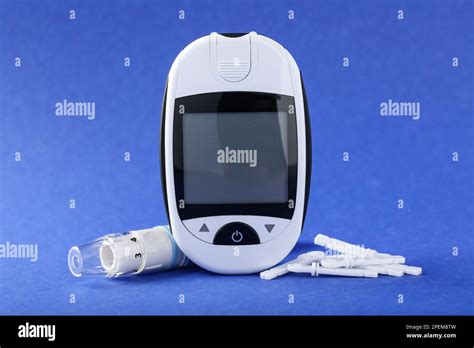 Digital Glucometer Lancets And Pen On Blue Background Diabetes