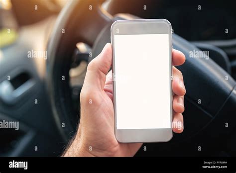 Using Smartphone In Car Mock Up Blank Screen Of Mobile Phone Device In Hand Of Adult Caucasian