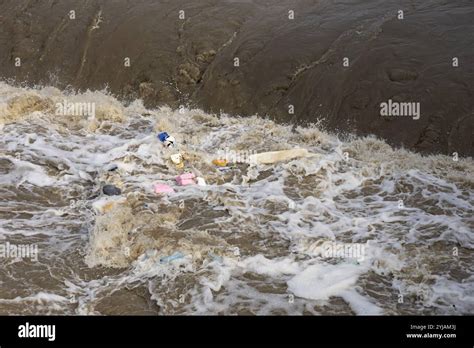 Floating Garbage And Debris Swept By Powerful River Currents After