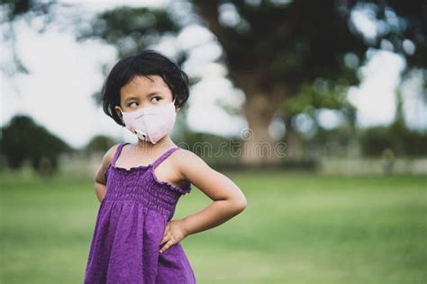 Cute Asian Small Girl In A Facial Mask Standing Outdoor Stock Photo Image Of Outdoor Standing