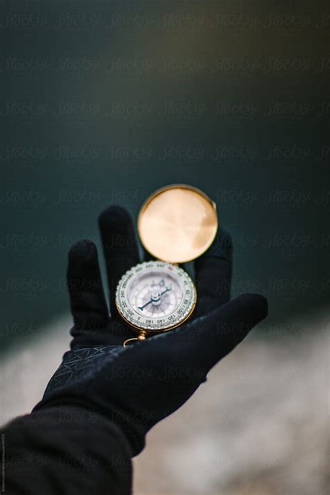 Compass Being Held Out To Determine Direction By Stocksy Contributor Kristen Curette