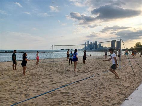 People Play Beach Volleyball At Sunset Editorial Photography Image Of