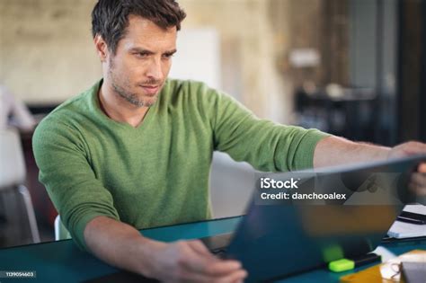 Young Software Developer In Coworking Open Space Using Computer Stock