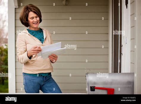 A Woman Checking Her Mailbox Stock Photo Alamy