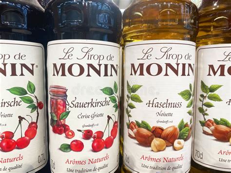 Closeup Of Bottles Monin Syrup In Shelf Of German Supermarket Editorial
