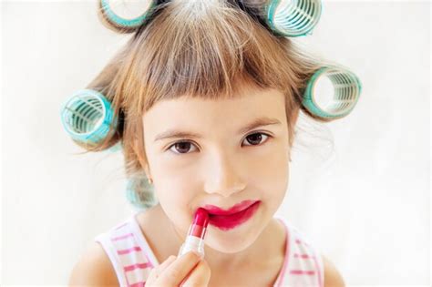Premium Photo Close Up Of Young Woman Applying Lipstick