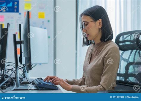 Asian Prompt Engineer Developer Coding App With Software Data Sitting