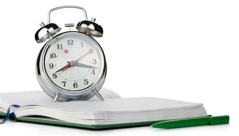 Premium Photo Alarm Clock On Notepad