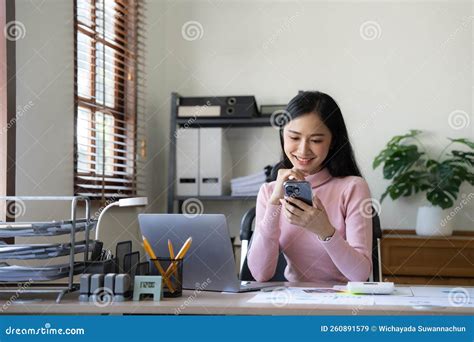 Smiling Beautiful Asian Businesswoman Analyzing Chart And Graph Showing