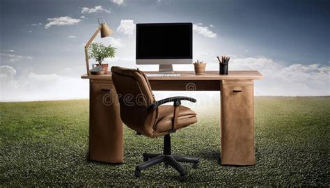 An Innovative Office Desk Setup On A Grassy Field With A Computer