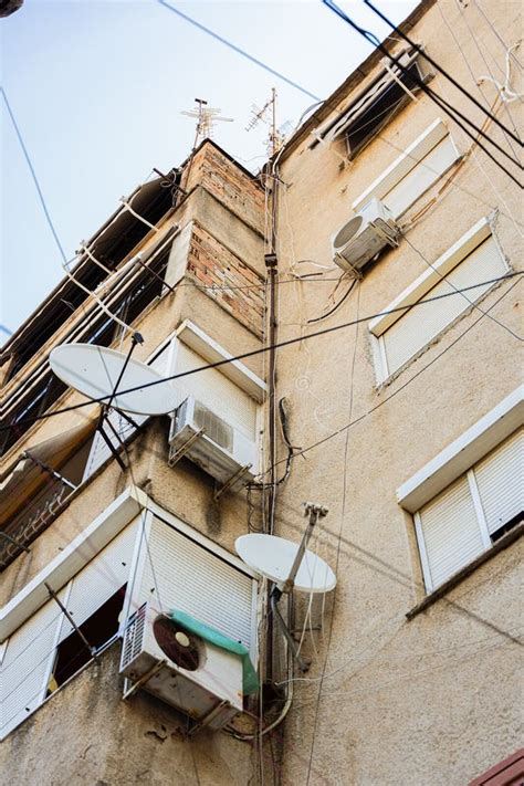 Old Brick Building With Ventilation Systems Wires And Cables On Each