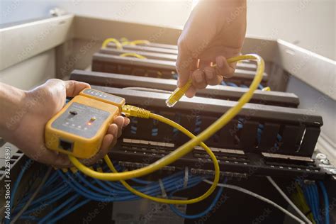 Hand With Network Cables Connected To Servers In A Datacenter Equipment Tester Cable Lan In The