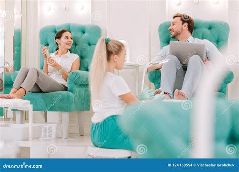 Couple Of Successful Businessmen Coming To Salon For Feet Massage Stock