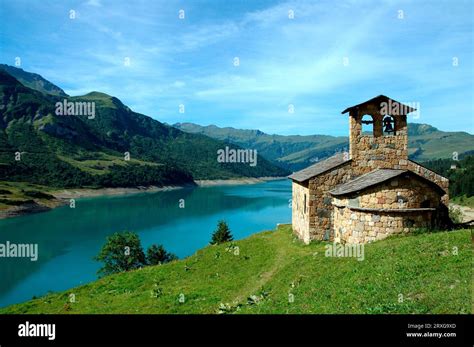 Chapel And Reservoir Lac De Roselend Haute Savoie France Alps Stock