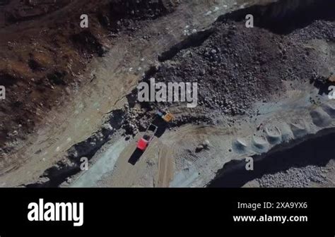 Yellow Excavator Loading Soil Into A Dumper Truck On Construction Site Excavator Loads A Dump