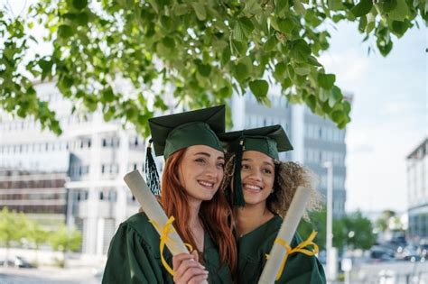 Premium Photo Two Young Women Recently Graduated From The University Showing Their Titles