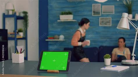 Tablet computer with mock up green screen chroma key display standing ...