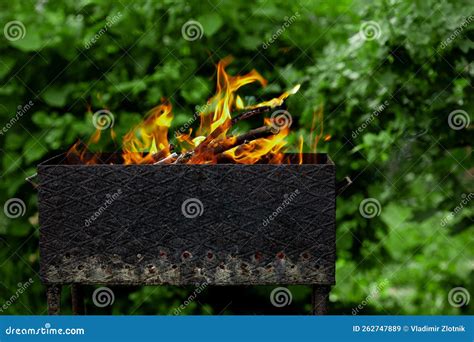 Burning Firewood In A Brazier In The Garden With Yellow Fire Flames Outdoors Stock Image Image