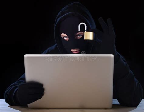 Dangerous Hacker Man With Computer And Lock Hacking System In Cyber Crime Concept Stock Image