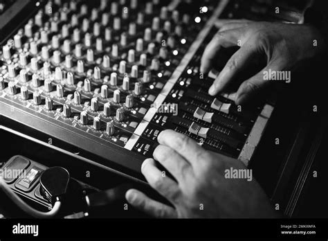 The Sound Engineer Works At The Mixing Console Mixing The Musical