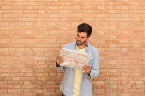 Free Photo Confused Man Looking At Map