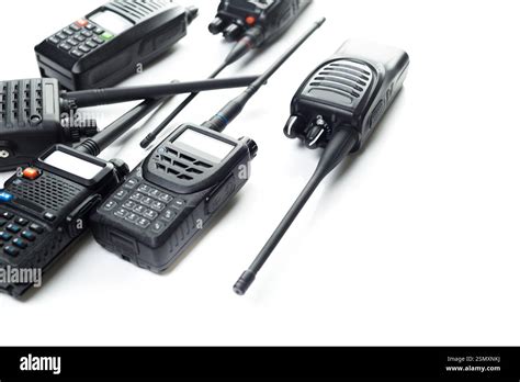 Communication Devices Arranged On A White Surface With Multiple Two Way Radios And Antennas