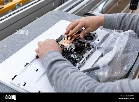 Photo Of Hands Of Man Who Assembles A Computer Monitor System Block On