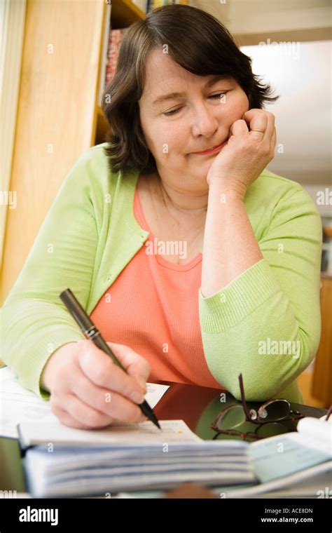 Woman Writing A Check Stock Photo Alamy