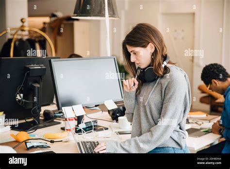 Female Computer Programmer Analyzing Data On Laptop At Desk In Office Stock Photo Alamy