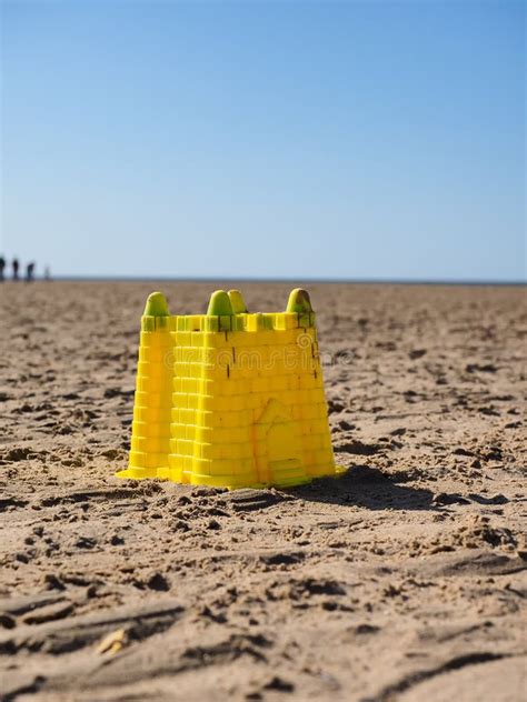 A Yellow Sand Castle Is Sitting On The Beach Stock Image Image Of