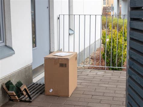 A Cardboard Parcel Is Delivered To A Residential Doorstep In Finland