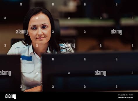 Female Security Operator Working In A Data System Control Room Offices